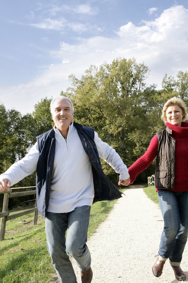 Couple Walking Hand in Hand Stock Image - Image of holding, people ...