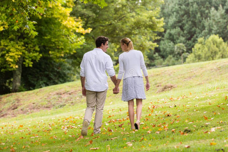 Couple Walking Hand in Hand Stock Photo - Image of holding, dating ...