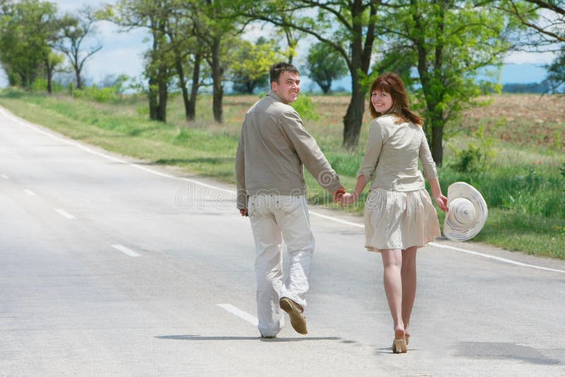 Couple Walking by Rural Road Stock Photo - Image of female, portrait ...