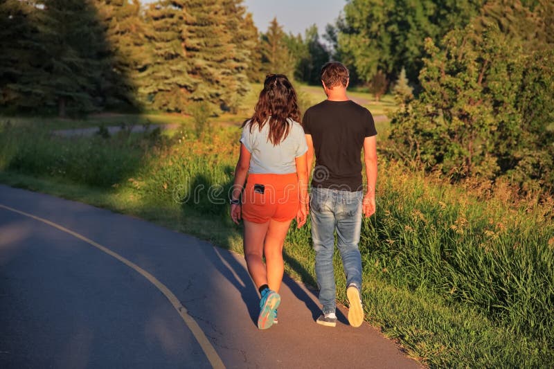 Couple Walking in Sunset on the Road Stock Image - Image of landscape ...