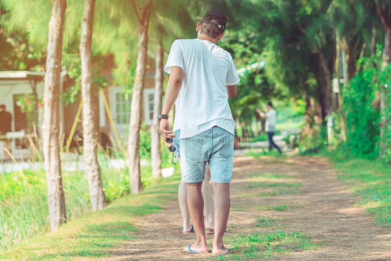 Couple Walking and Taking Photos Under the Pine Trees Editorial ...