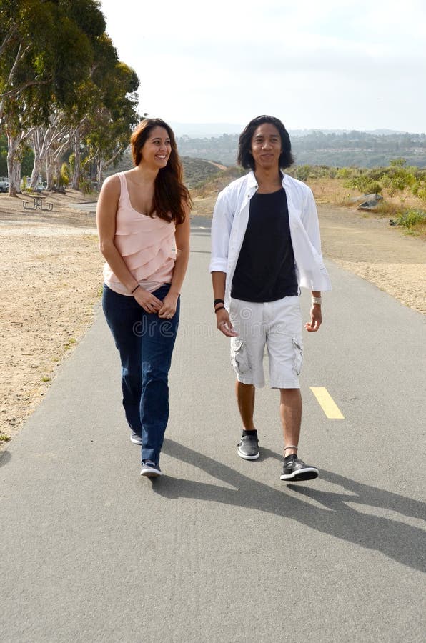 Couple Walking and Talking stock image. Image of activity - 25121579