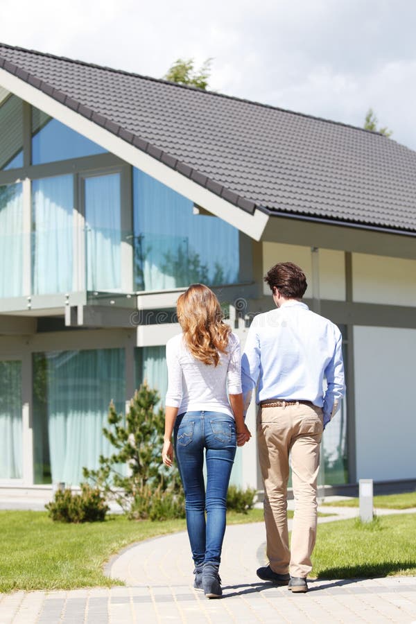 Couple Walking Towards House Stock Photo - Image of people, jeans: 56000344