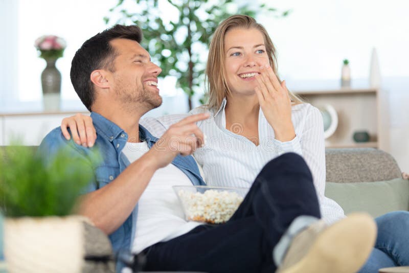 Couple Watching Movie Eating Pop Corn on Sofa Stock Photo - Image of ...