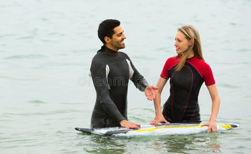 Couple in Wetsuits with Surf Boards Stock Image - Image of friends ...