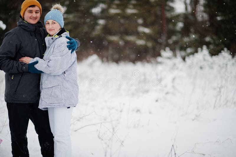 Couple at Winter Day. Walking in the Park on Cold Day with Snow and ...