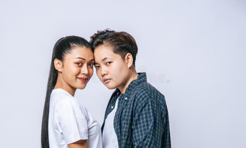 A Couple of Women Standing and Looking Forward Stock Image - Image of ...