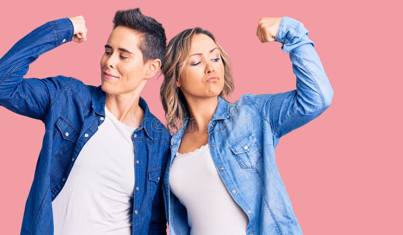 Couple Of Women Wearing Casual Clothes Showing Arms Muscles Smiling