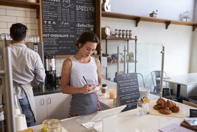 Couple Working Behind The Counter At A Coffee Shop, Close Up Stock ...