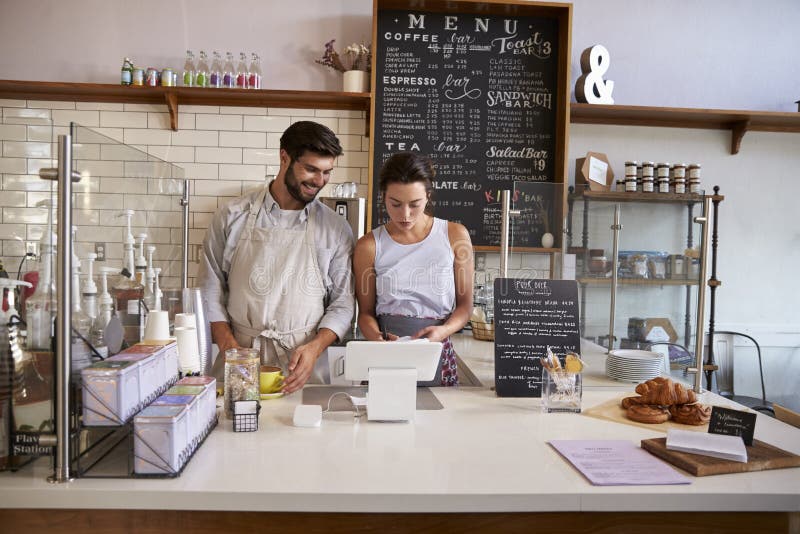 Couple Working Together at the Till in a Coffee Shop Stock Image ...