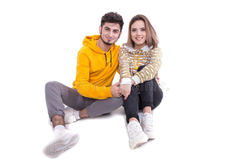 Couple in Yellow Sitting on White in Studio Stock Image - Image of girl ...