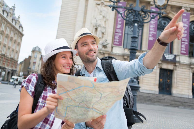 Couple of Young Attractive Tourists Watching Map Stock Image - Image of ...