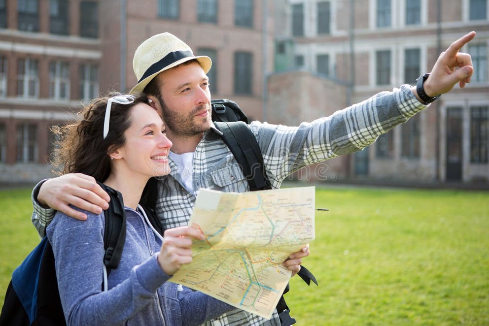 Couple of Young Attractive Tourists Watching Map Stock Photo - Image of ...