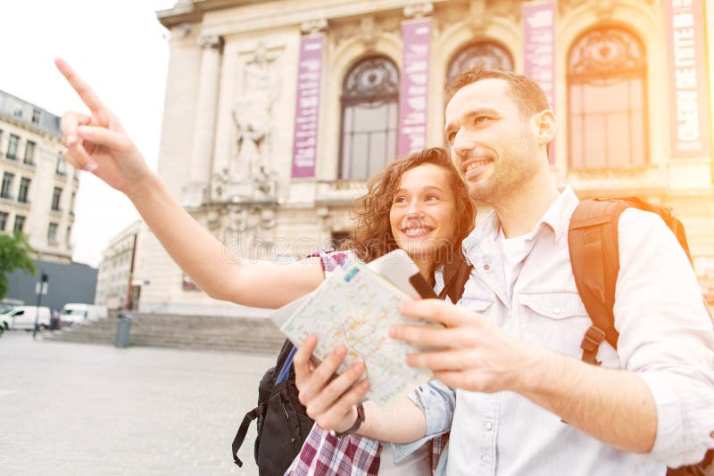 Couple of Young Attractive Tourists Watching Map Stock Photo - Image of ...