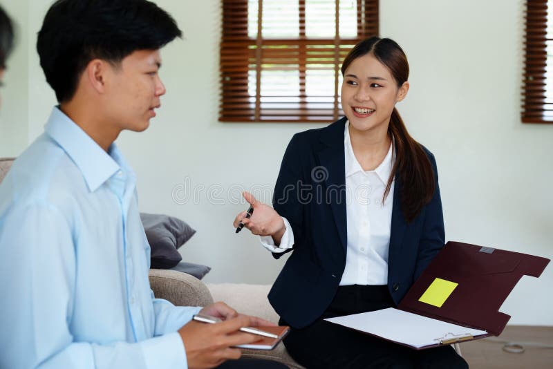 Couples Consult with a Representative To Plan an Insurance Contract ...