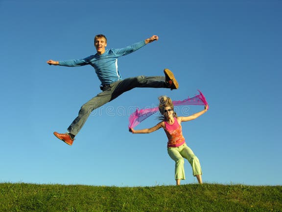 Couples jump on grass stock image. Image of physical, freedom - 221203