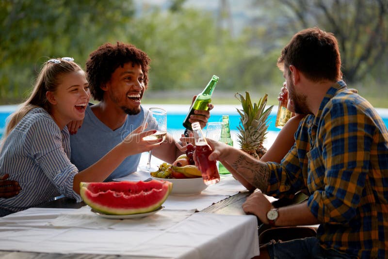 Couples Sitting at the Table by the Pool, Talking, Smiling, Laughing ...