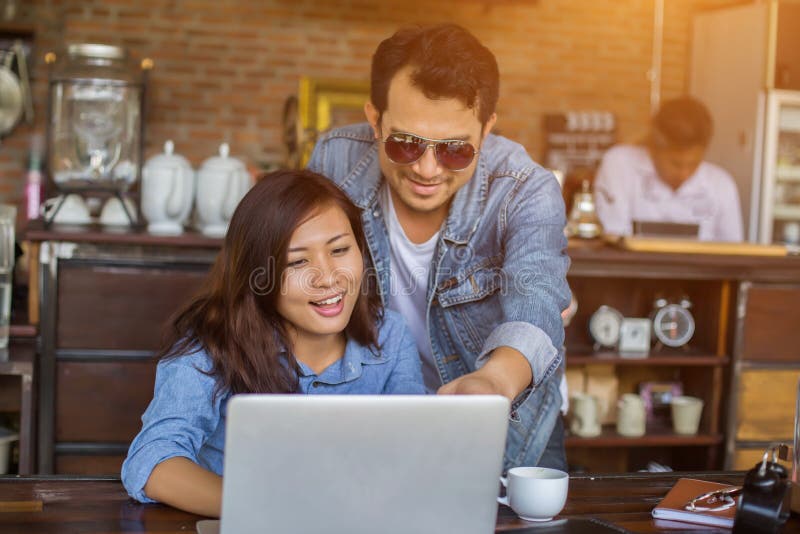 Couples Using Laptops To Work Together. Stock Image - Image of ...