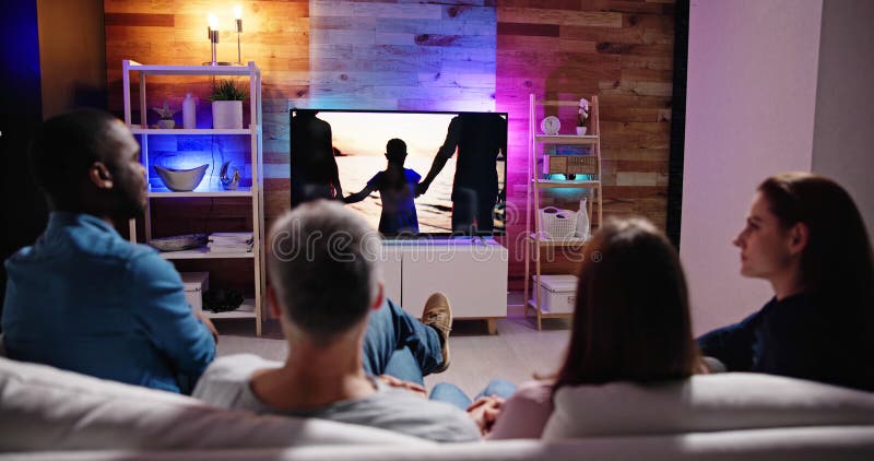 Couples Watching TV at Night Stock Photo - Image of film, multiracial ...