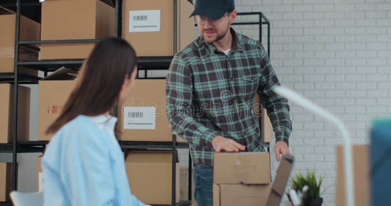 The Courier Comes To Pick Up the Package for the Customer. Female ...