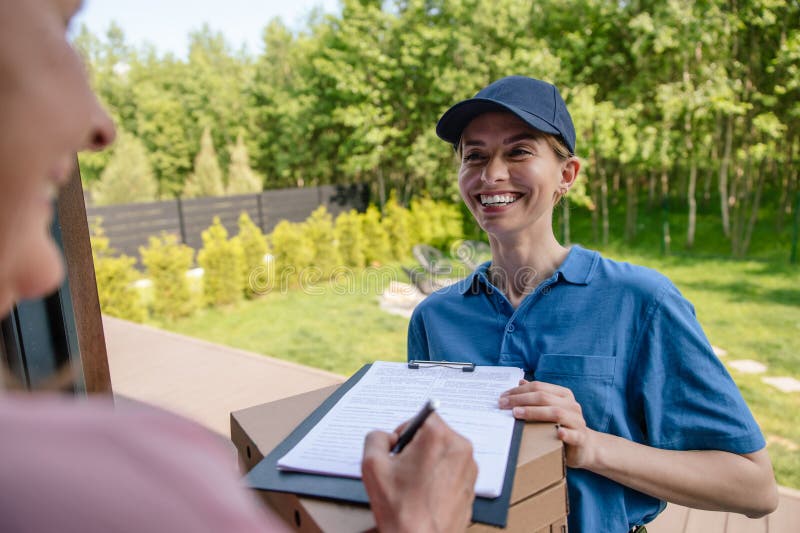 Courier Delivering Parcel, Customer Signs the Delivery Documents. Stock ...