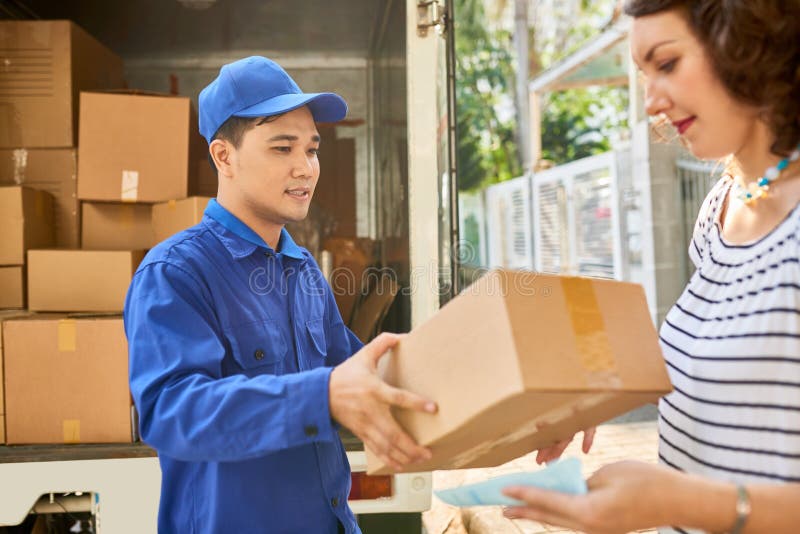 Courier delivering parcel stock image. Image of service - 135269073