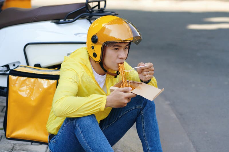 Courier Eating Noodles for Lunch Stock Image - Image of scooter, yellow ...