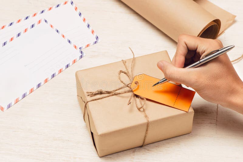 Courier Hands Writing on Cardboard Box at Table. Stock Photo - Image of ...
