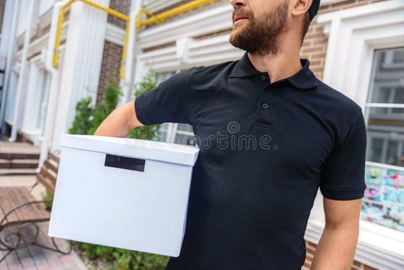 Courier Holding a Box in Front of House Stock Image - Image of cargo ...