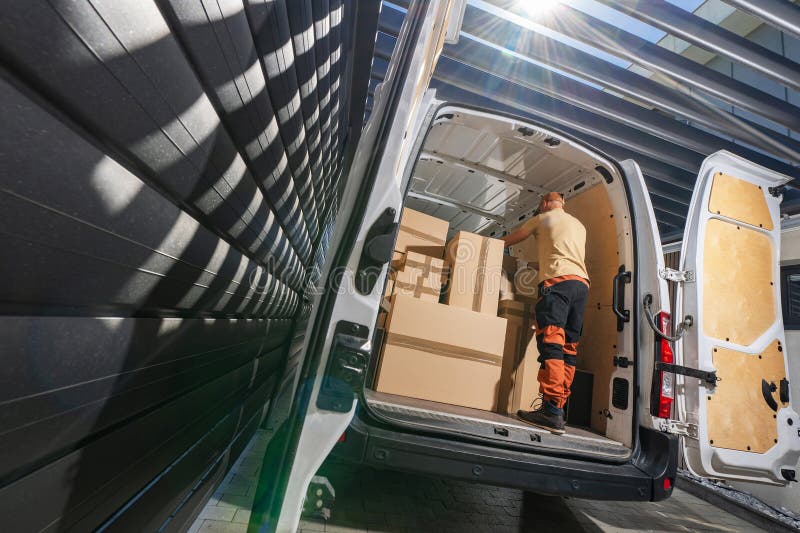 Courier Loading Cargo Boxes into Van for Delivery Stock Image - Image ...