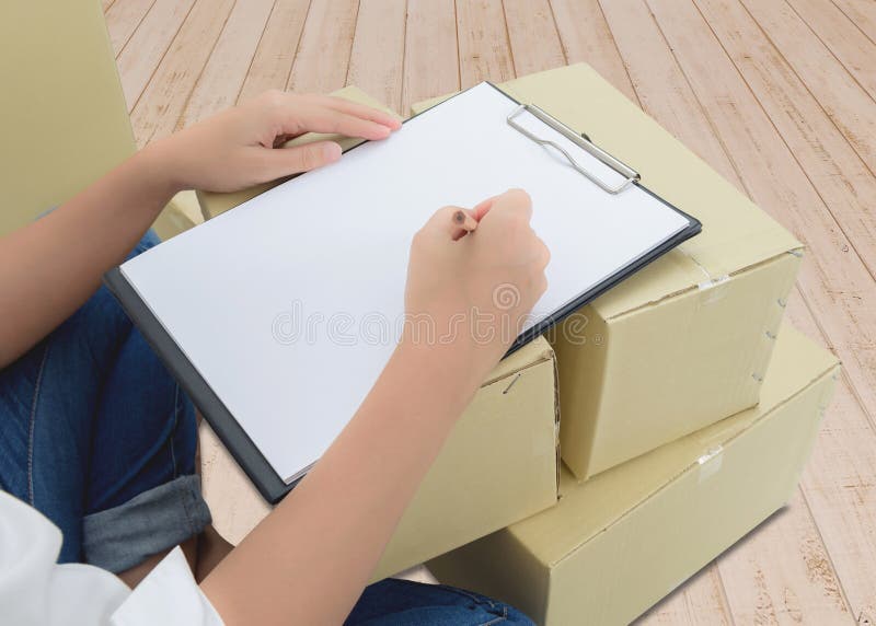 Courier Making Notes in Delivery Receipt among Parcels on Boxes Stock ...