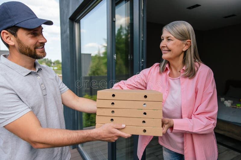 Courier Man Handling Pizza To Female Client. Stock Image - Image of ...