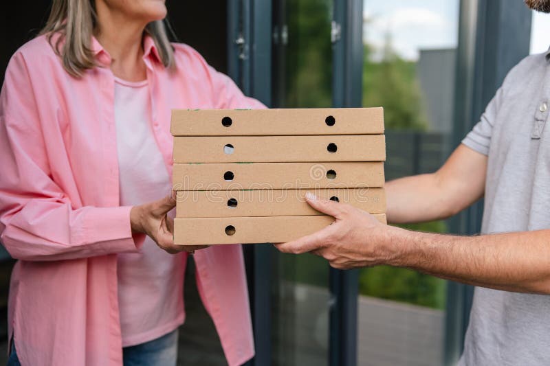 Courier Man Handling Pizza To Female Client. Stock Image - Image of ...