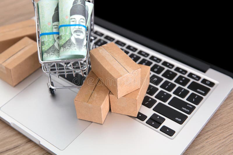 Courier Package on the Computer Keyboard and a Shopping Cart with ...