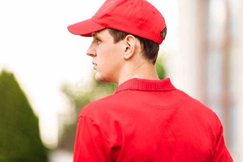 A Courier in a Red Uniform. Online Stores and Express Delivery Stock ...