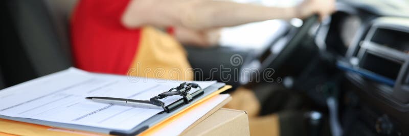 Courier in Uniform in Car and Receipt Documents on Clipboard for Client ...