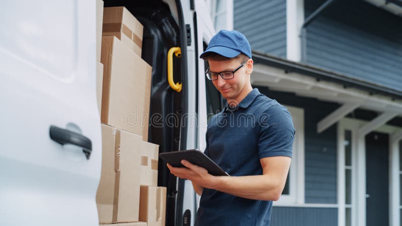 Courier Using Tablet Computer Next To Open Delivery Van Side Door with ...