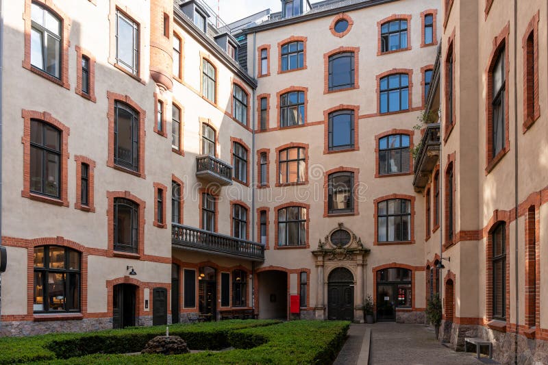 A Courtyard with a Brick Building and a Red Sign Stock Photo - Image of ...