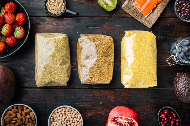 Couscous, Bulgur and Polenta in Pack, Flat Lay on Dark Wooden ...