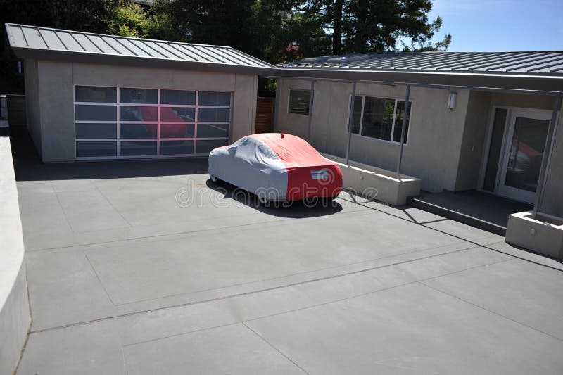Covered Car Sits in Driveway of Modern House Stock Photo - Image of ...