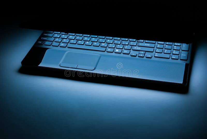 The Covered Laptop with the Light in the Dark Stock Image - Image of ...