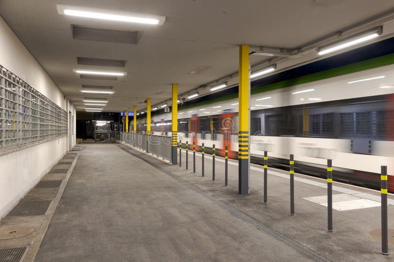 Covered Station Platform Illuminated by Led Lights. the Train Passes by ...