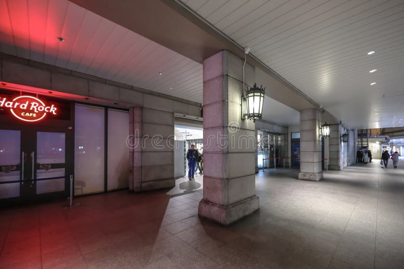 Covered Walkway with Neon Sign and Stone Columns at Night Dec 9 2024 ...