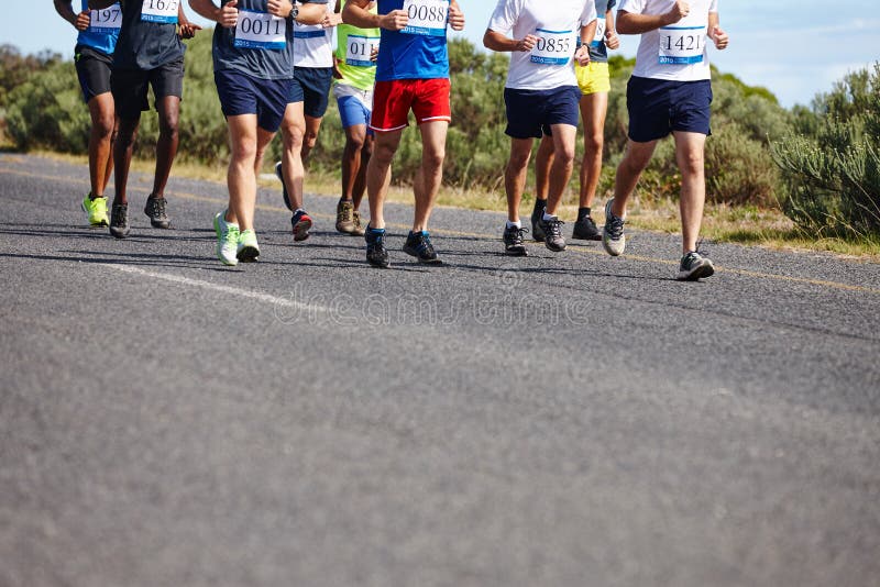 Covering the Miles. a Group of Men Running a Marathon. Stock Photo ...