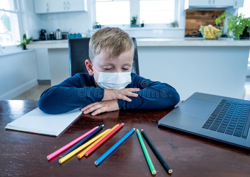 COVID-19 and Remote Learning. Bored Kid with Mask Studying Online ...
