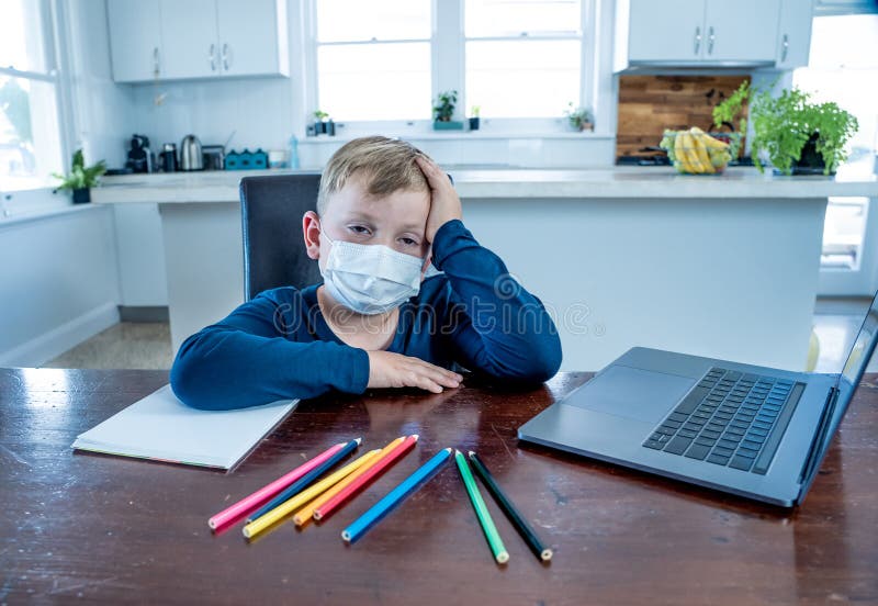 COVID-19 and Remote Learning. Bored Kid with Mask Studying Online ...