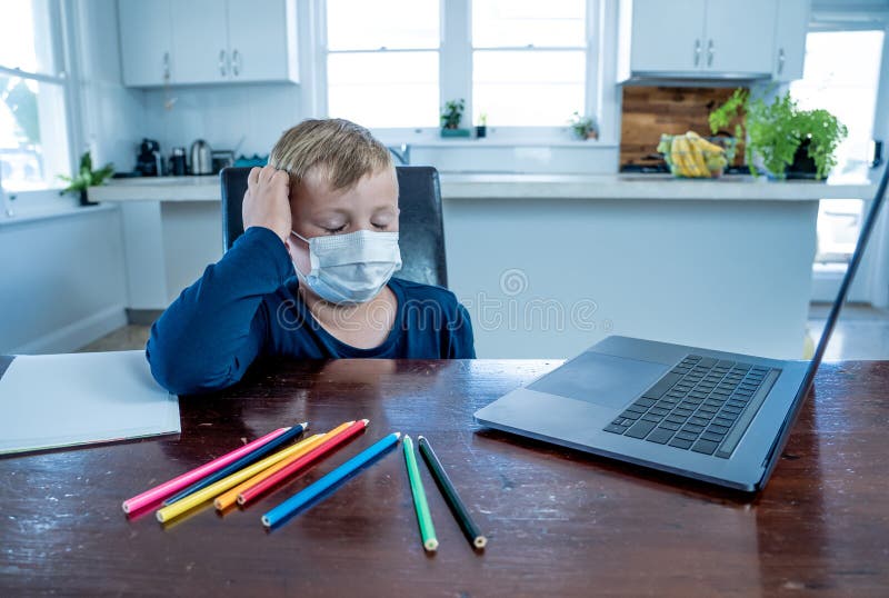 COVID-19 and Remote Learning. Bored Kid with Mask Studying Online ...