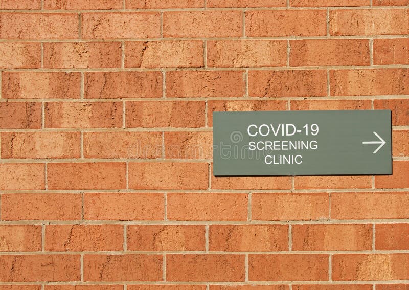 COVID-19 Screening Clinic Sign on a Red Brick Wall Stock Photo - Image ...