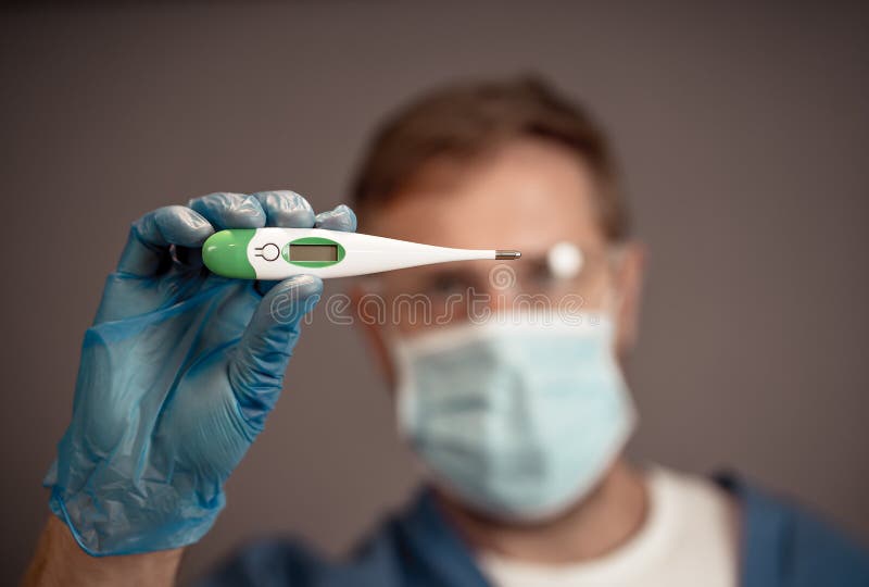 COVID-19 Symptoms and Prevention. Doctor with Surgical Mask Holding ...