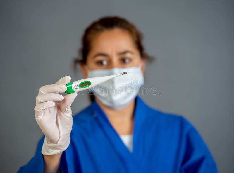 COVID-19 Symptoms and Prevention. Doctor with Surgical Mask Holding ...